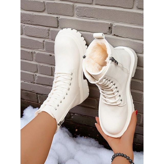 Svarta damstövlar i konstläder med foder i konstpäls och snörning för ...